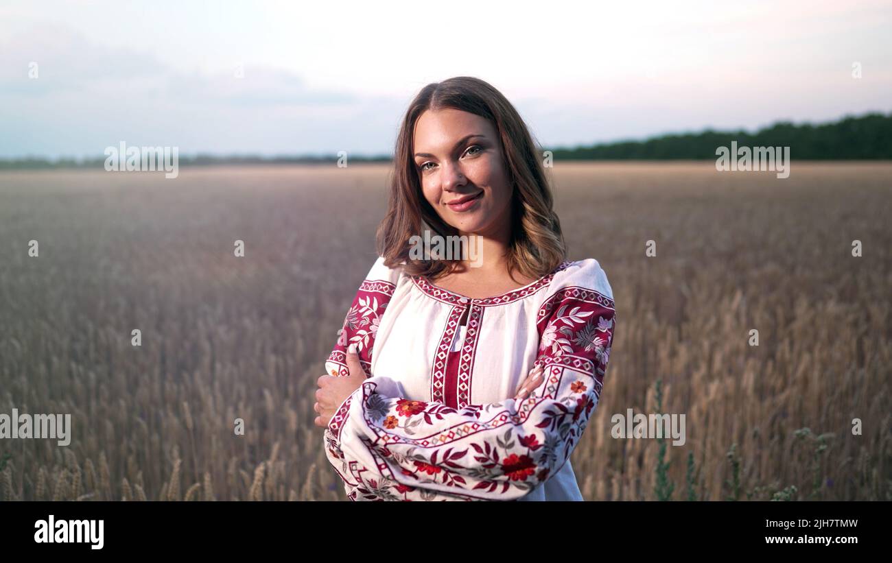 Smiling ukrainian woman in yellow ripe wheat field. Young lady in ...
