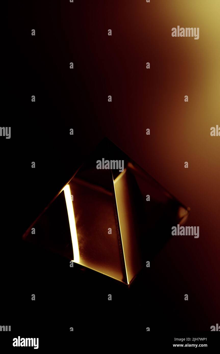 Dark abstract background with a shiy object. Glass object in the dark ...