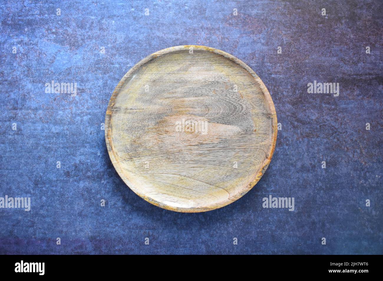 Round empty wooden plate made from acacia wood Stock Photo - Alamy