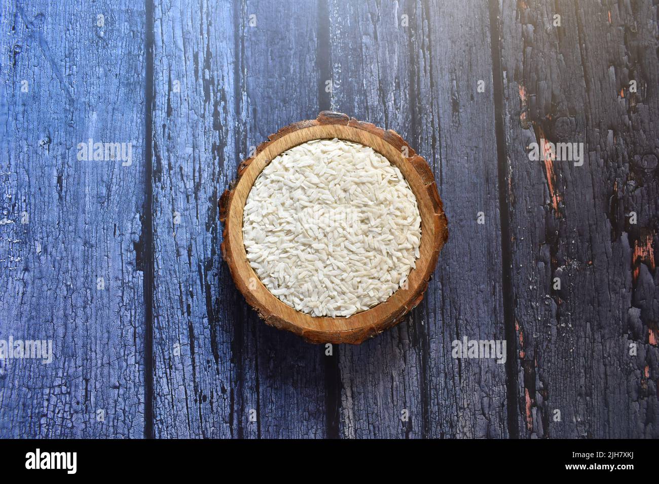 Raw whole dried flattened rice flakes Stock Photo - Alamy