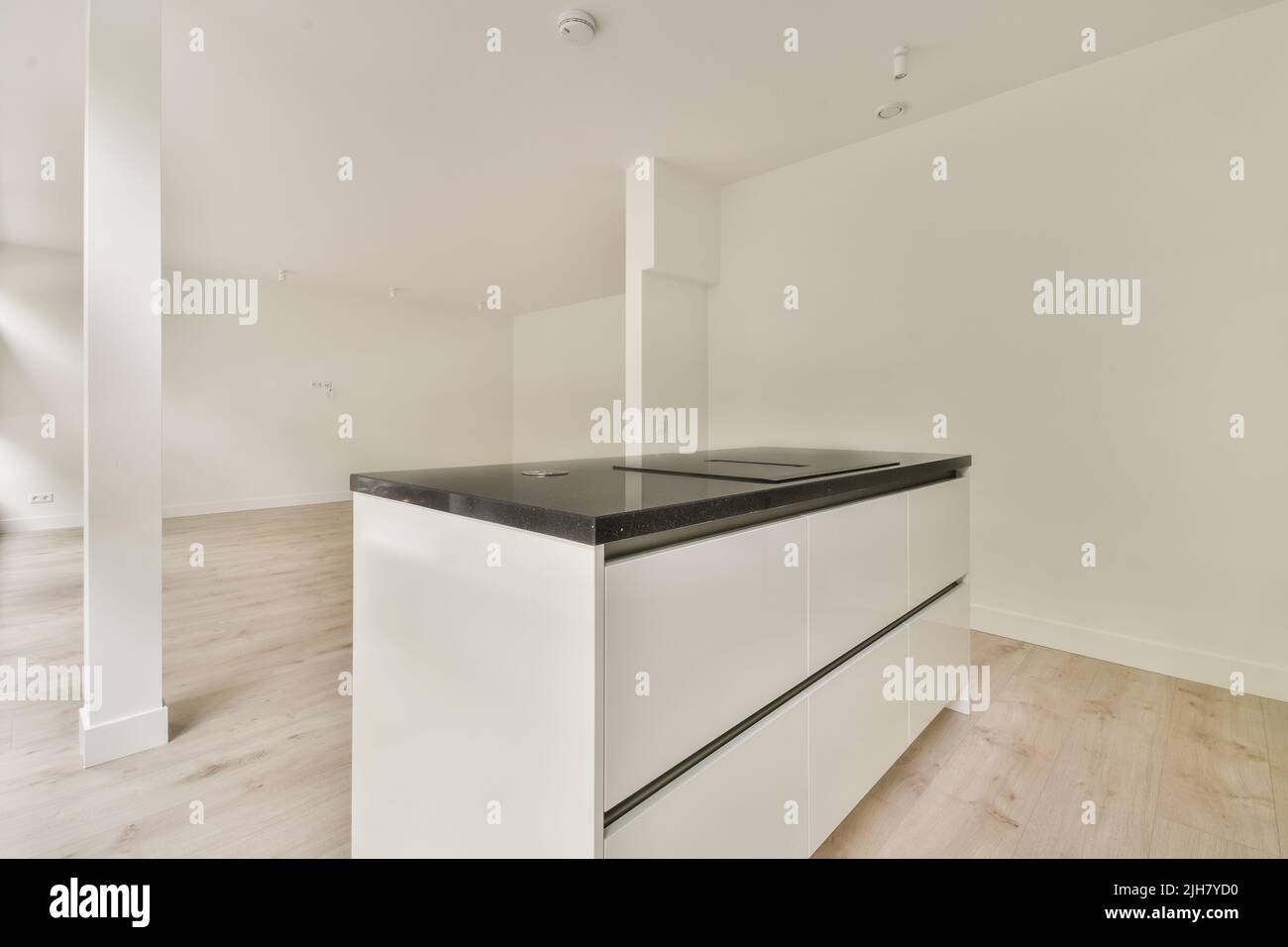 Interior of empty white kitchen with windows and wooden parquet floor ...