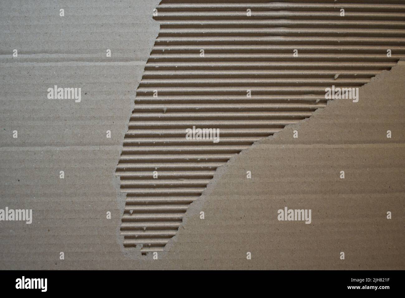 Dark brown color ripped cardboard textured background Stock Photo - Alamy