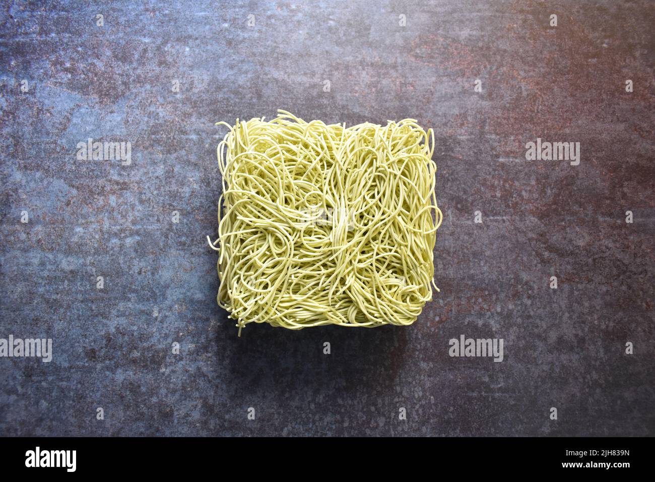 Raw whole dry light green color square noodles block Stock Photo - Alamy