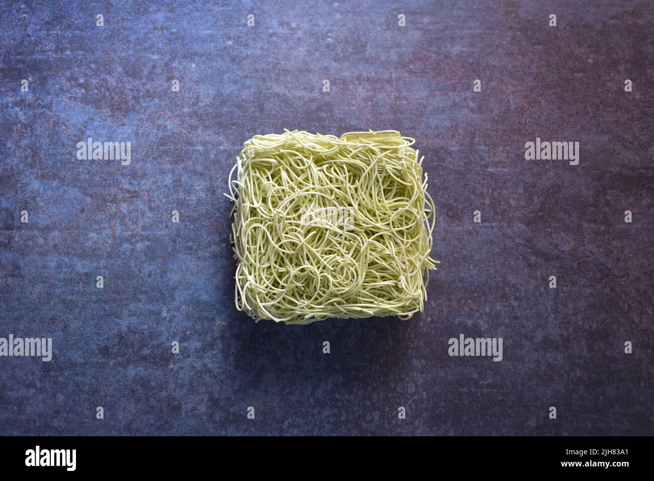 Raw whole dry light green color square noodles block Stock Photo - Alamy