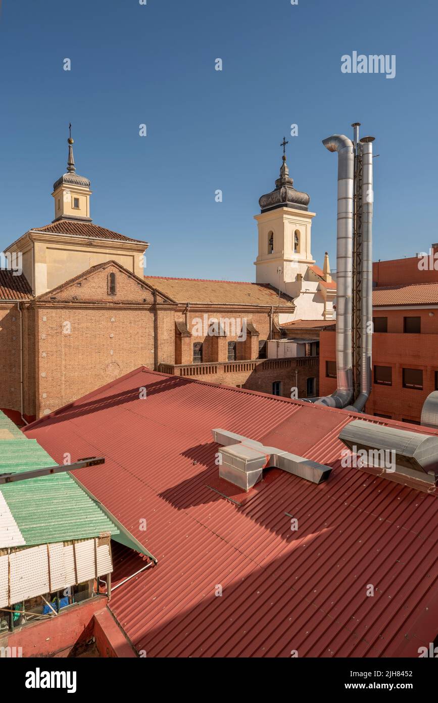 Interior facades with red metal roofs, stainless steel chimneys and ...