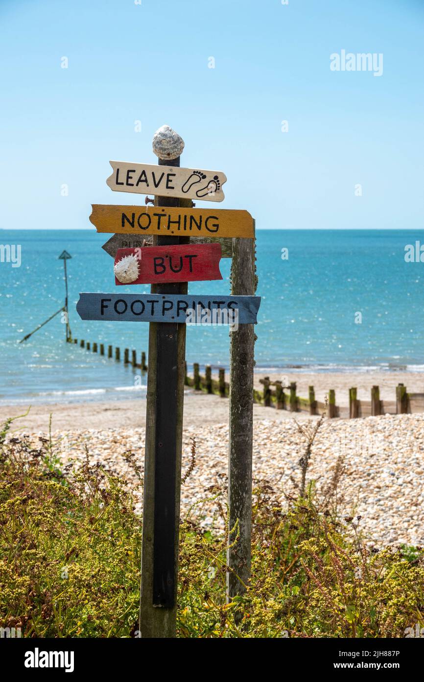 wooden sign post on beach leave nothing but footprints Stock Photo - Alamy