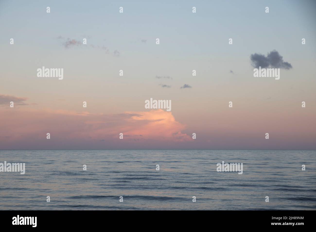 Clouds during sunset on a beach Stock Photo - Alamy