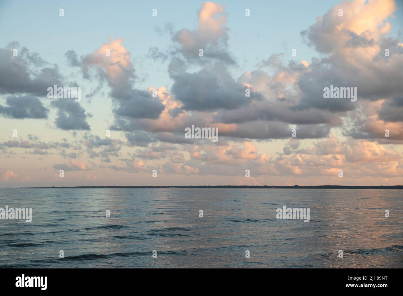 Clouds during sunset on a beach Stock Photo - Alamy