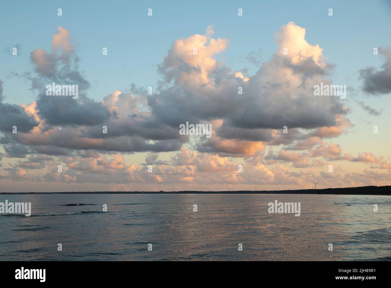 Clouds during sunset on a beach Stock Photo - Alamy