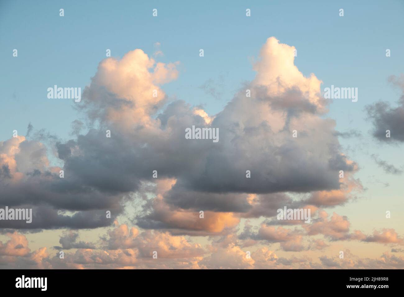 Clouds during sunset on a beach Stock Photo - Alamy