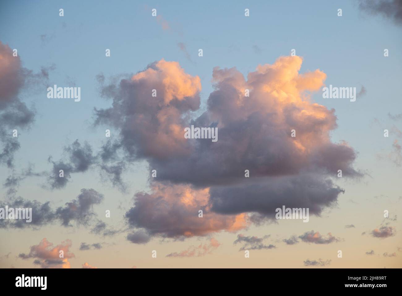 Clouds during sunset on a beach Stock Photo - Alamy