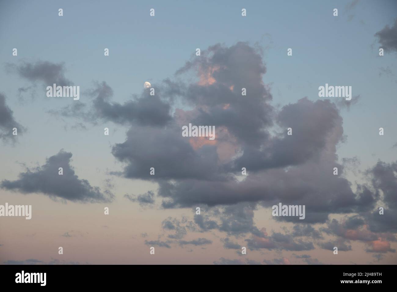 Clouds during sunset on a beach Stock Photo - Alamy