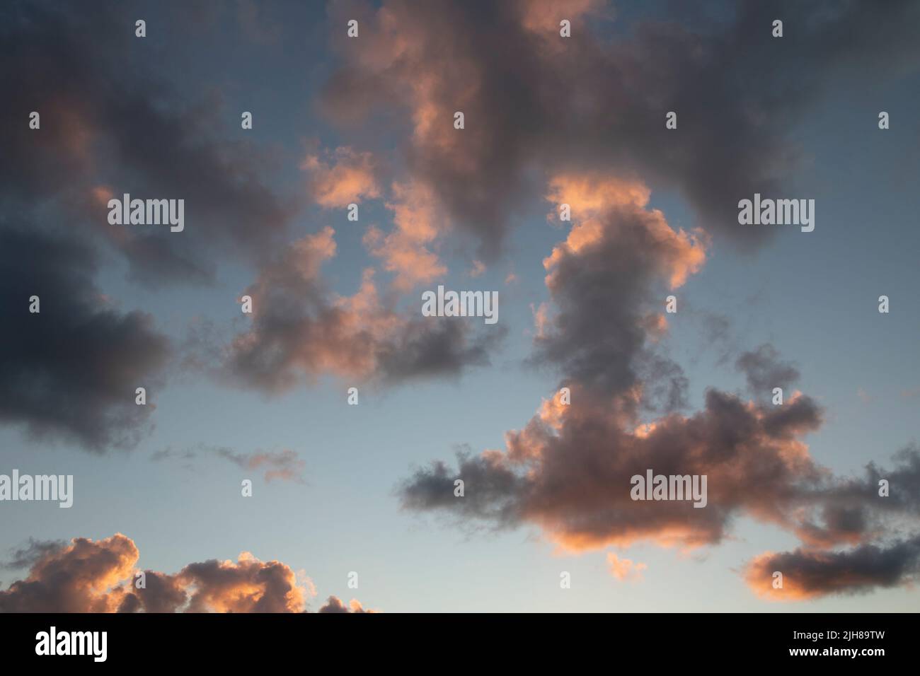 Clouds during sunset on a beach Stock Photo - Alamy