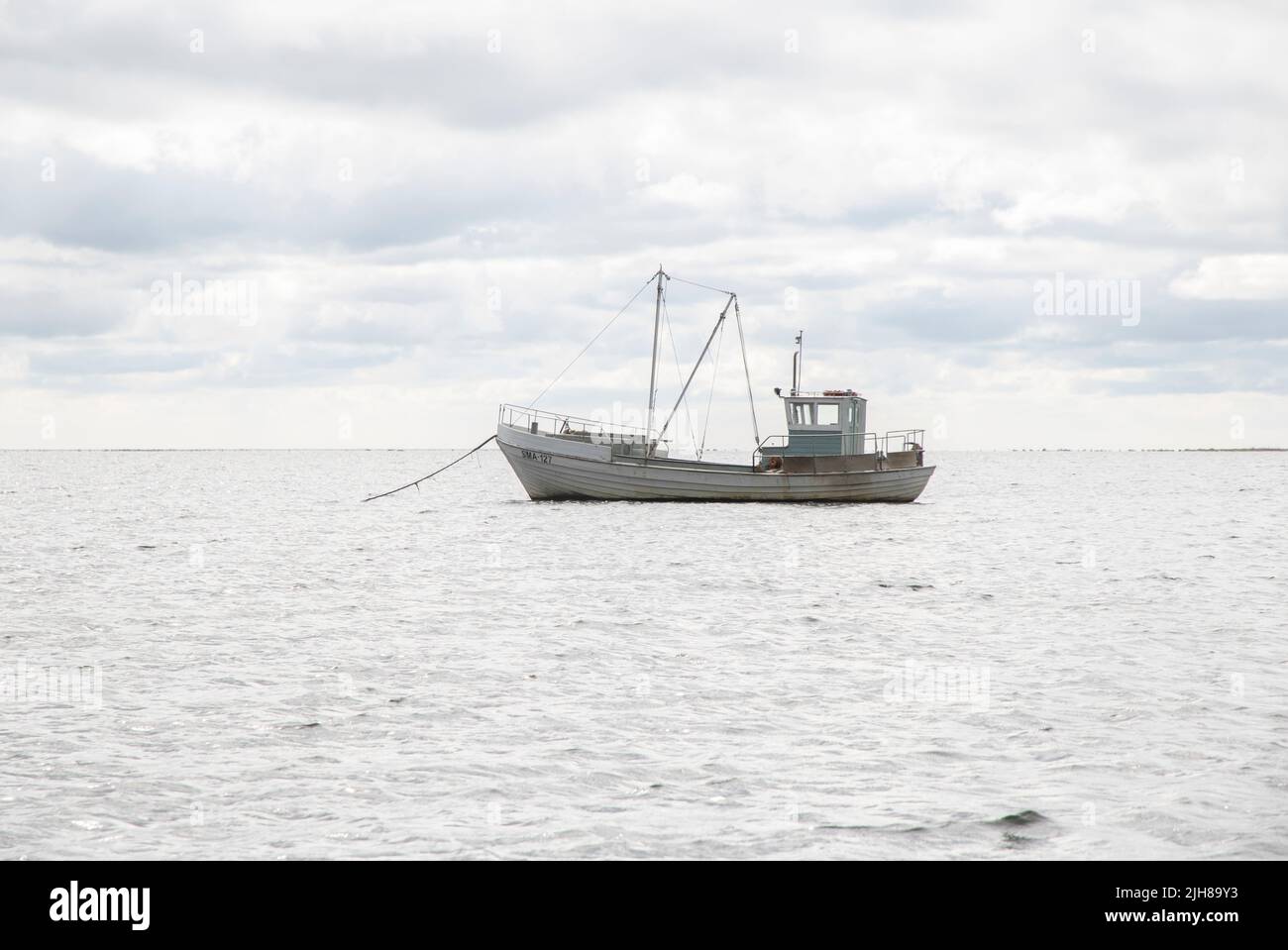Anchored fishing boat Stock Photo - Alamy