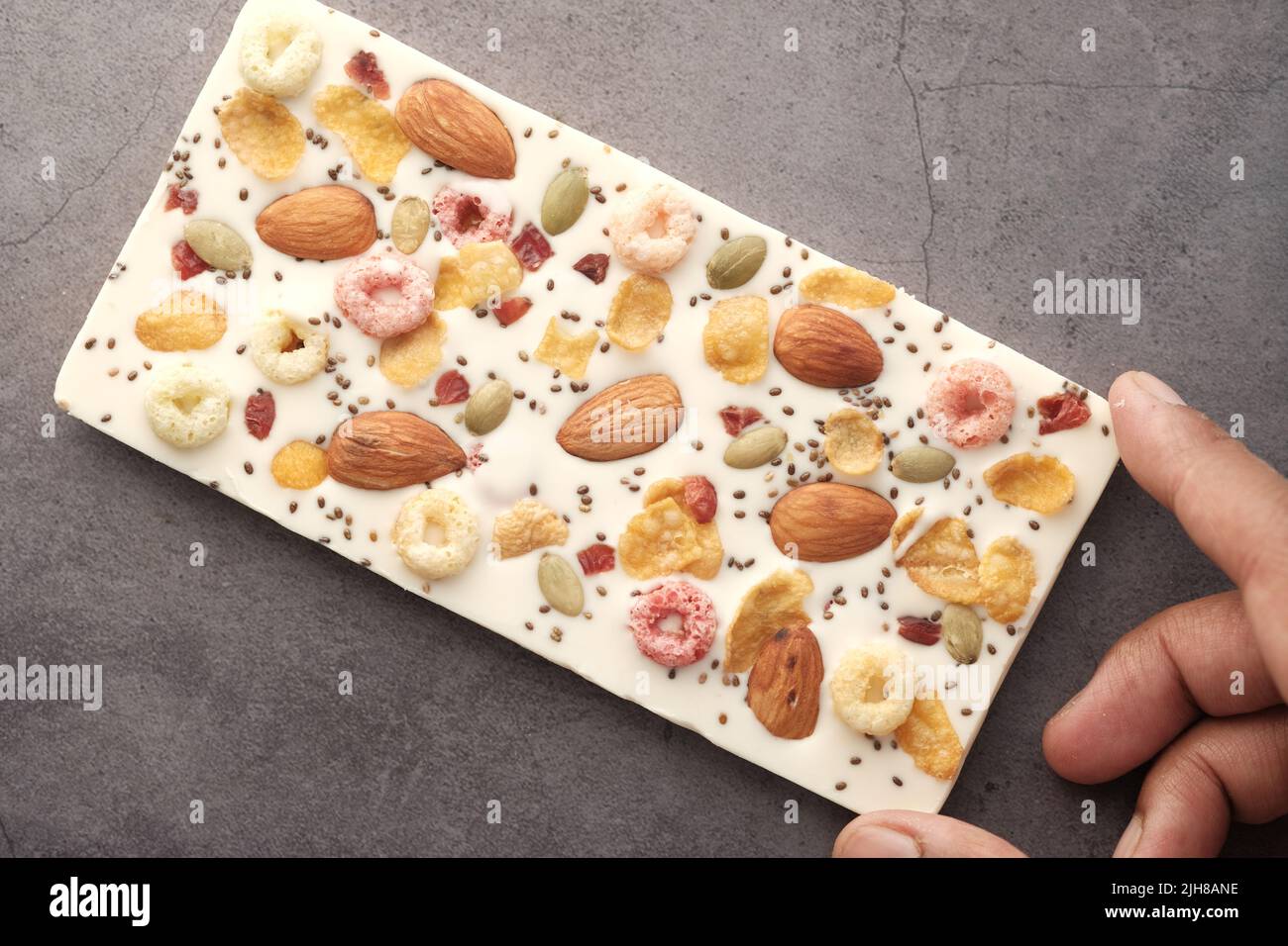 Nut candy in white chocolate on white backgorund Stock Photo - Alamy