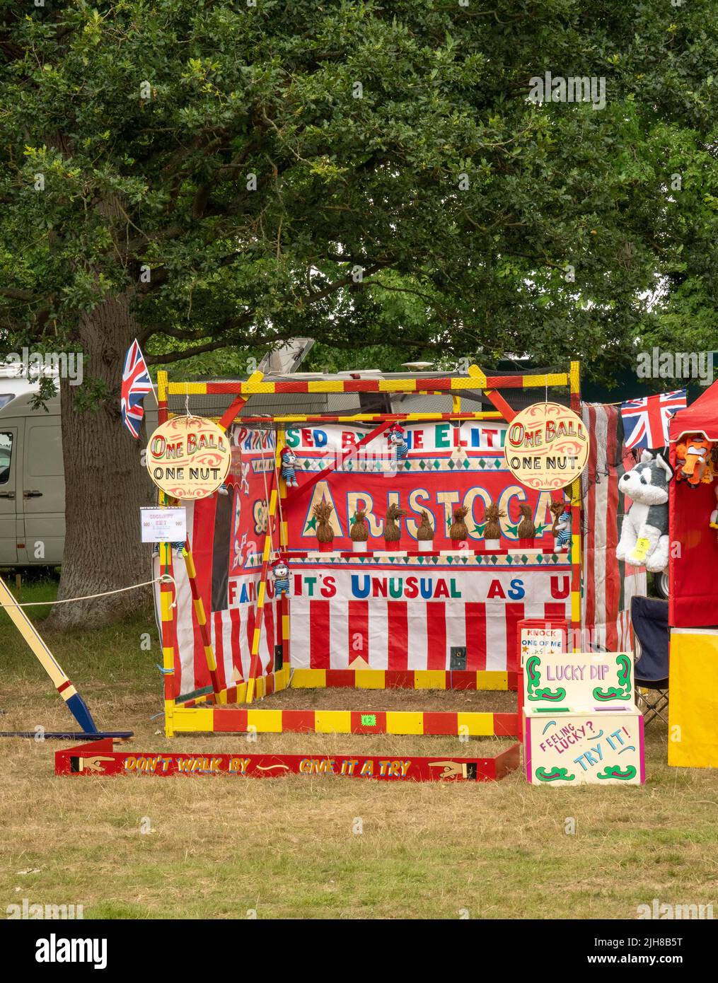 Coconut shy fairground game, knock a coconut off to win Stock Photo - Alamy