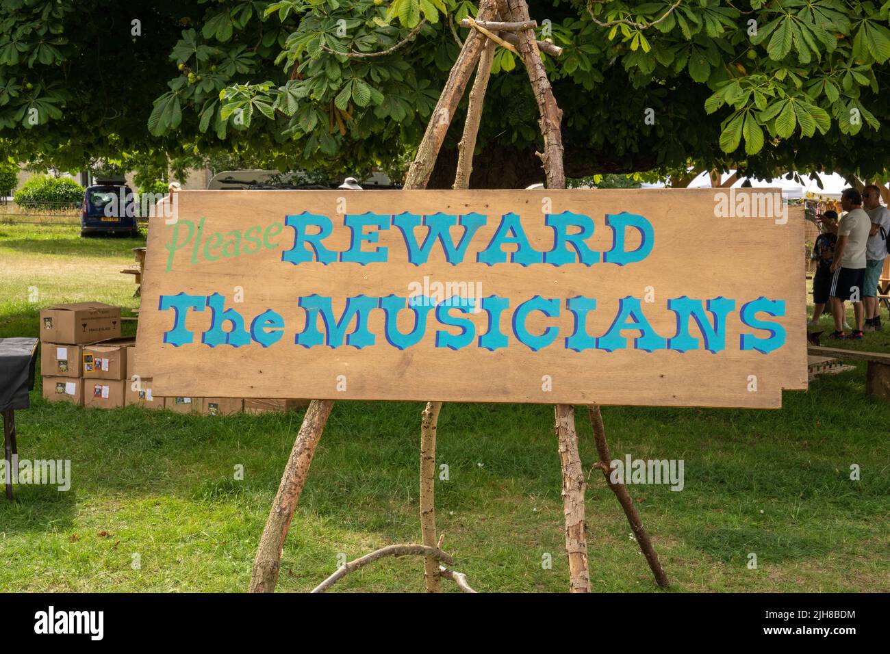 A view of a wooden sign with the words saying "Reward the Musicians" at ...