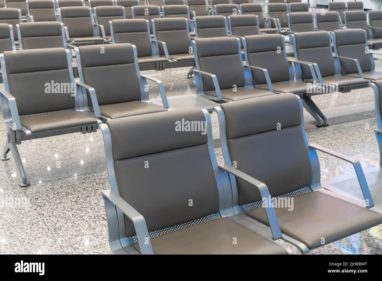 A close-up shot of empty chairs in the hallway of the public building's ...