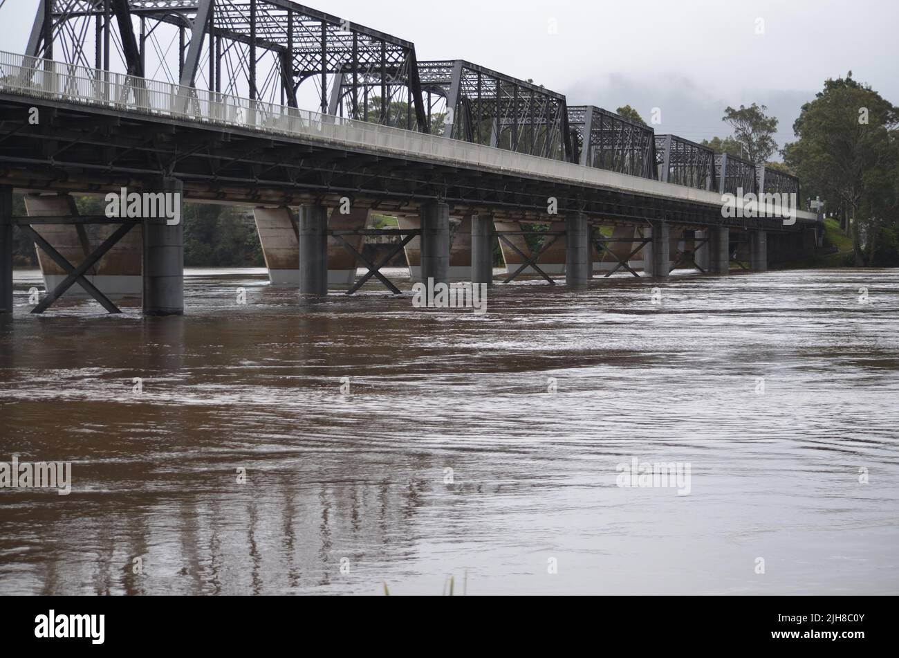 A tall and long bridge in the river Stock Photo - Alamy
