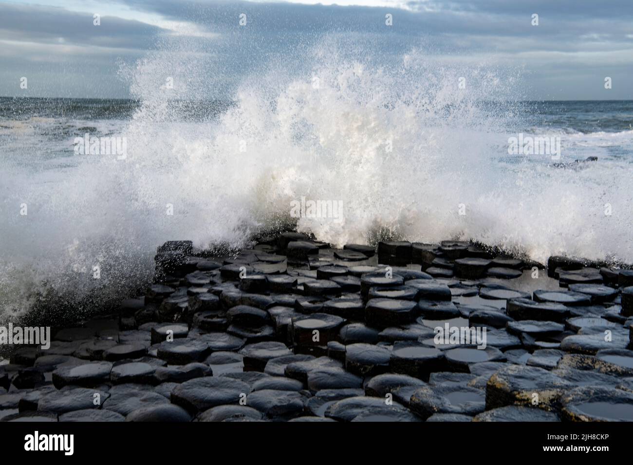 A scenic view of water splashing at interlocking basalt columns of ...