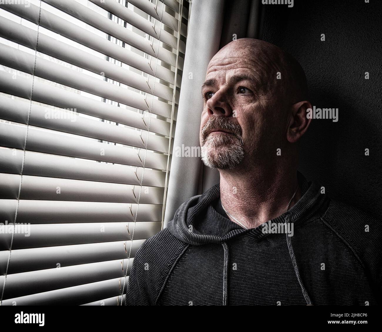 A middle-aged man looks to the future for hope whilst falling into a ...