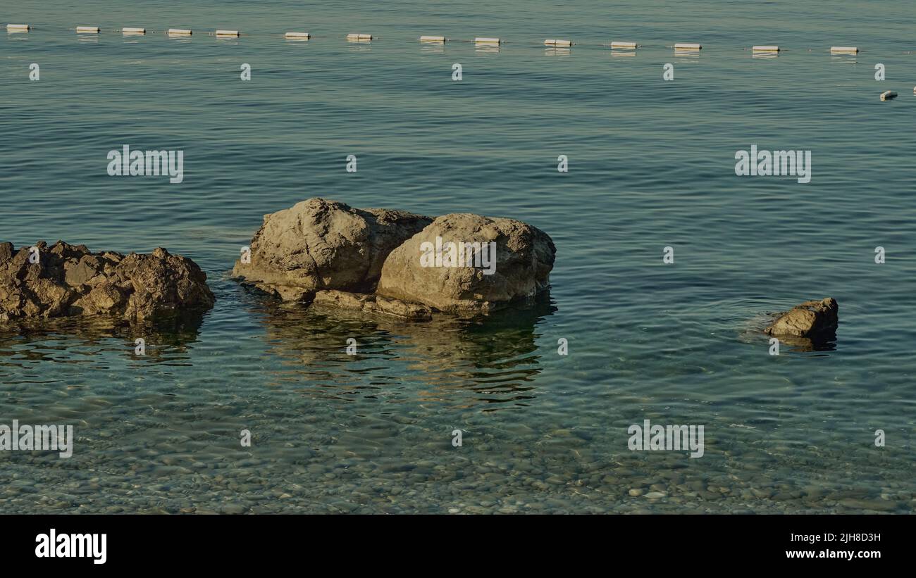 Stones near beach and buoys for swimmers Stock Photo - Alamy