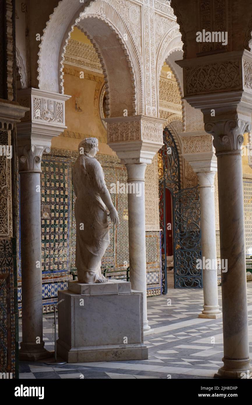 A vertical shot of a statue in the yard of an old medieval building ...