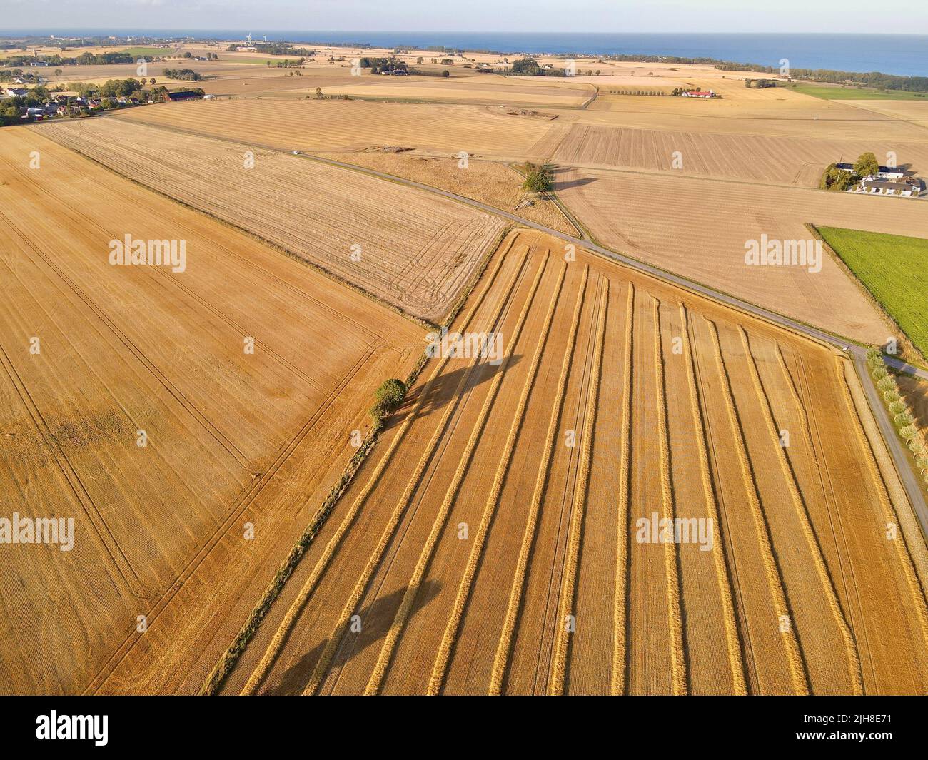 An aerial shot of a countryside with agricultural plowed fields with ...