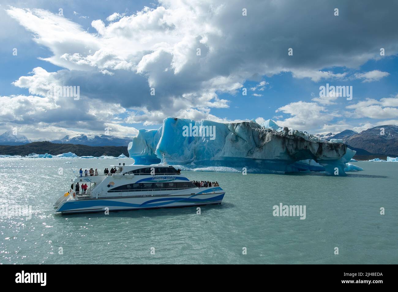 An iceberg and ship on Argentino Lake in the Patagonian province of ...