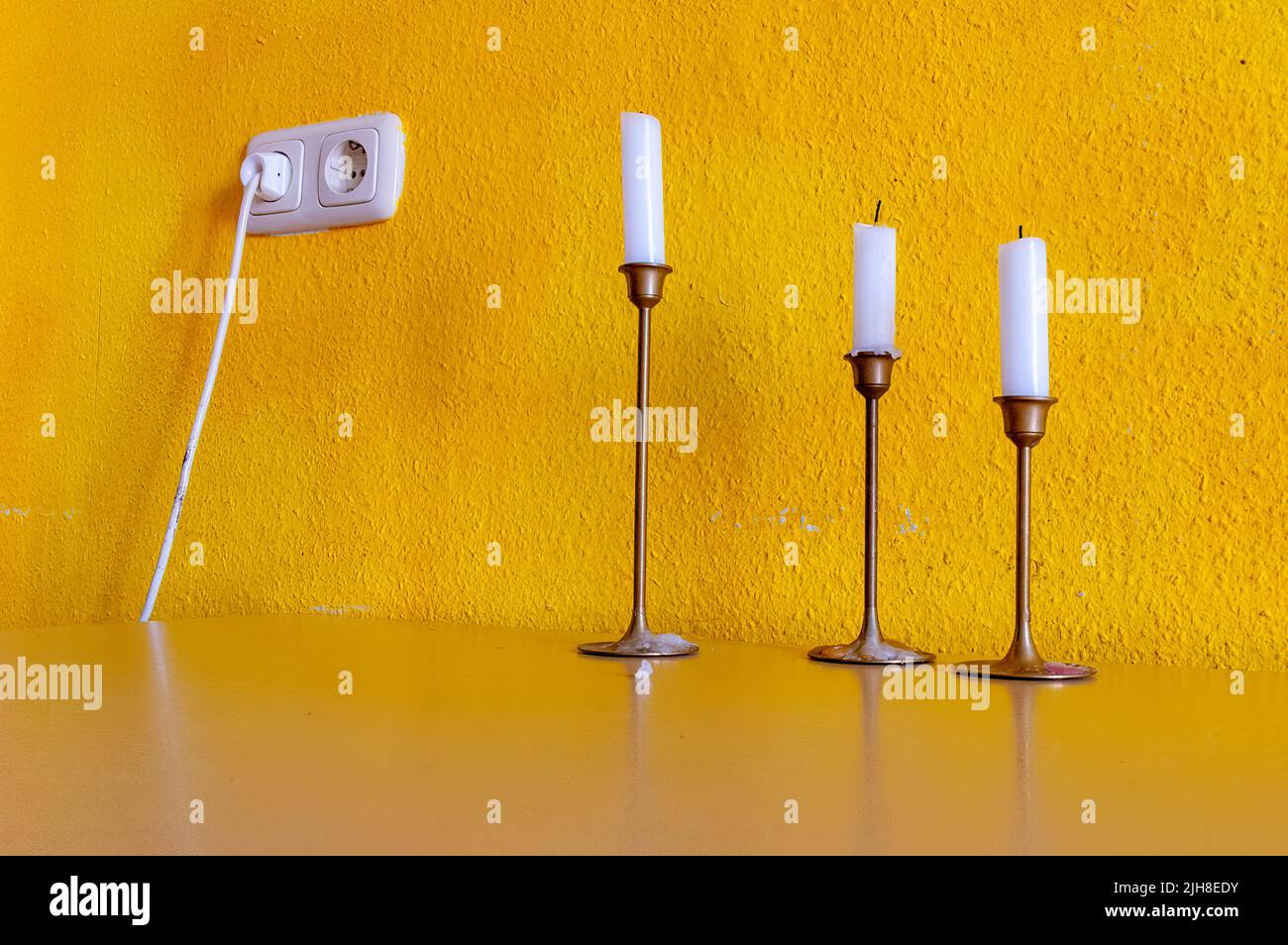 The White Candles On The Candle Holders Near A Yellow Wall With A Power Socket Stock Photo Alamy the-white-candles-on-the-candle-holders-near-a-yellow-wall-with-a-power-socket-stock-photo-alamy