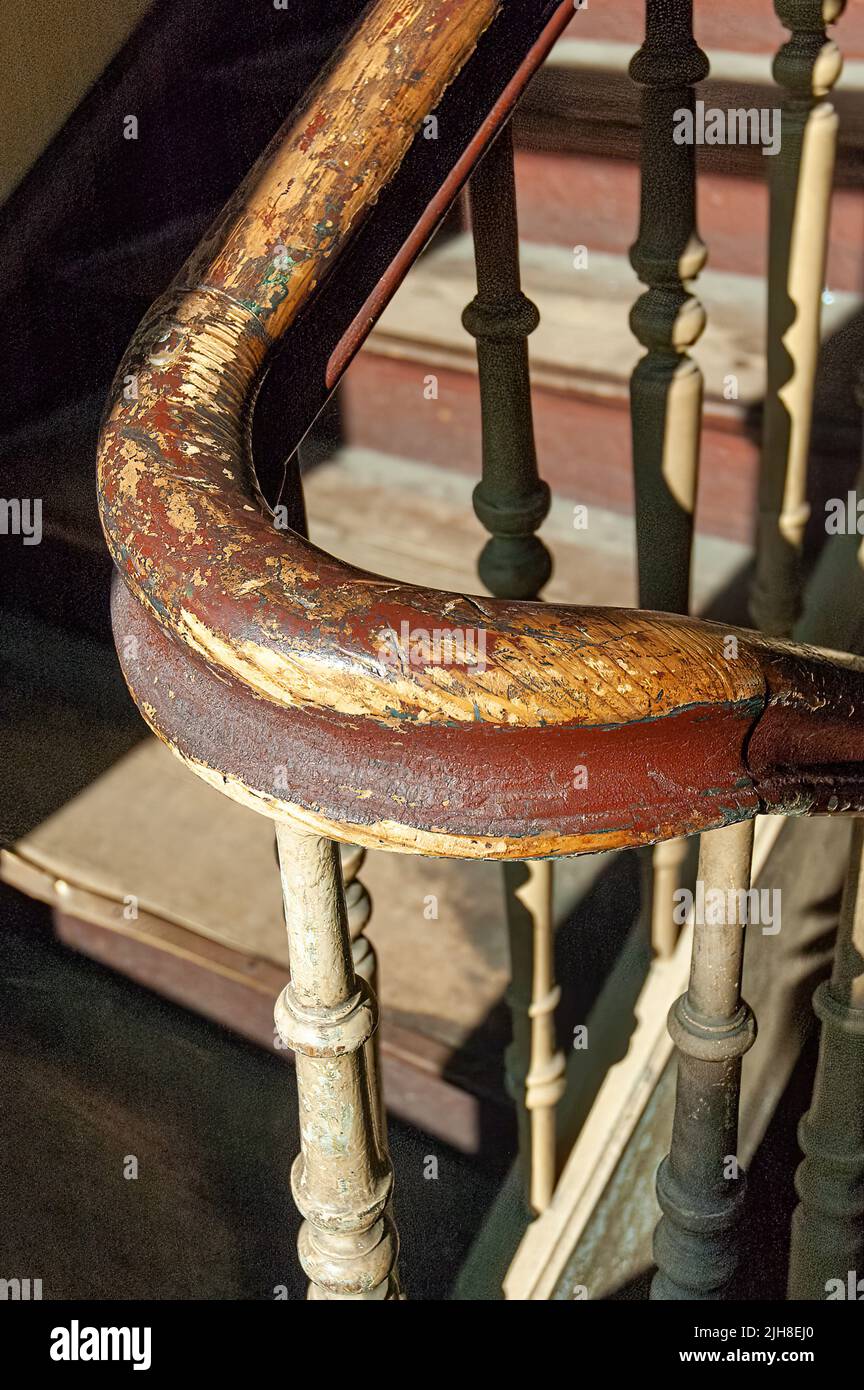 A vertical shot of the peeled wooden railing of an old staircase Stock ...