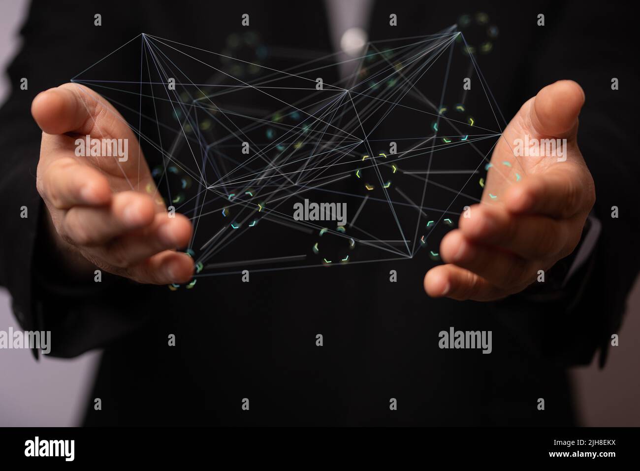 A businessman holding a floating render of web lines Stock Photo - Alamy