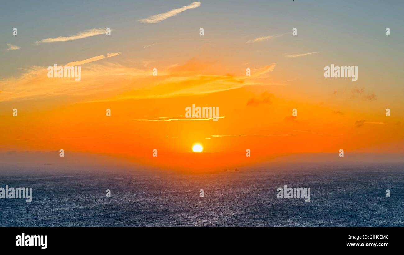 A splendid scenery of sunset with the sun coming down on the horizon ...
