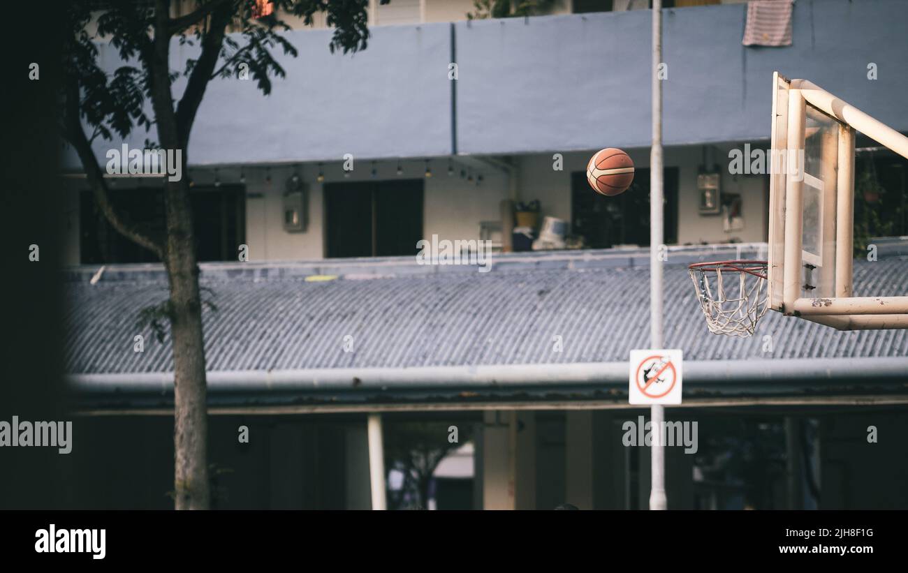 A basketball ball entering the rim with a splash Stock Photo - Alamy