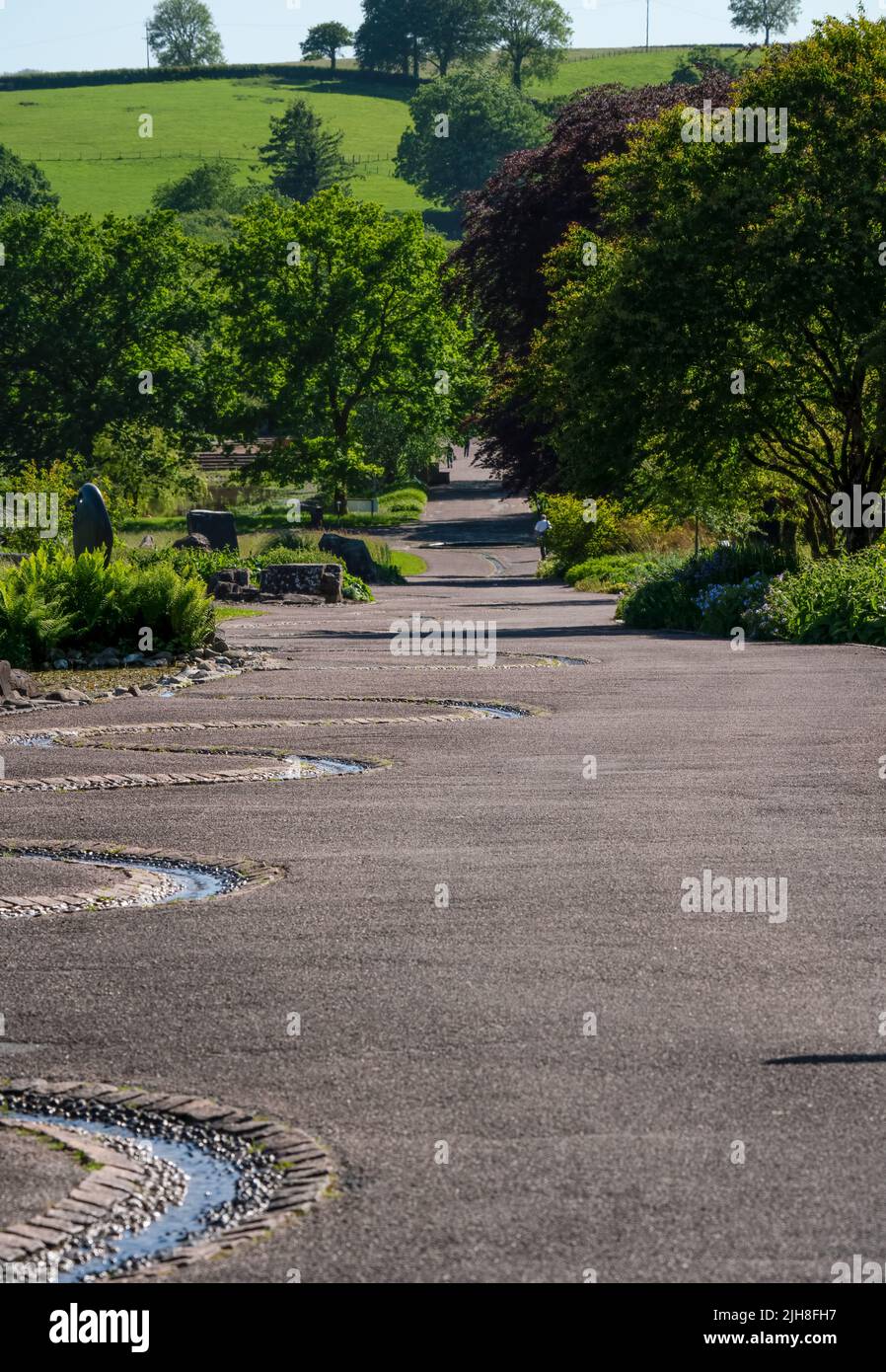 view of winding man-made pebbled stream meandering through wide ...