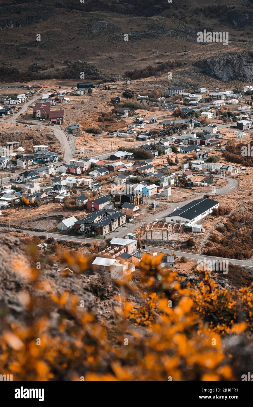 The vertical top-view of countryside buildings and streets on an autumn ...