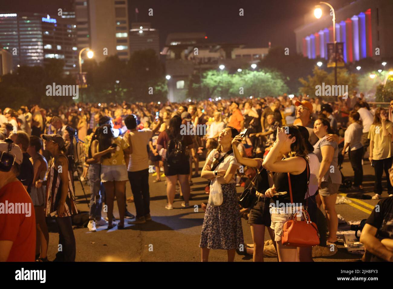 A crowd of people at night watching fireworks at Nashville downtown in ...