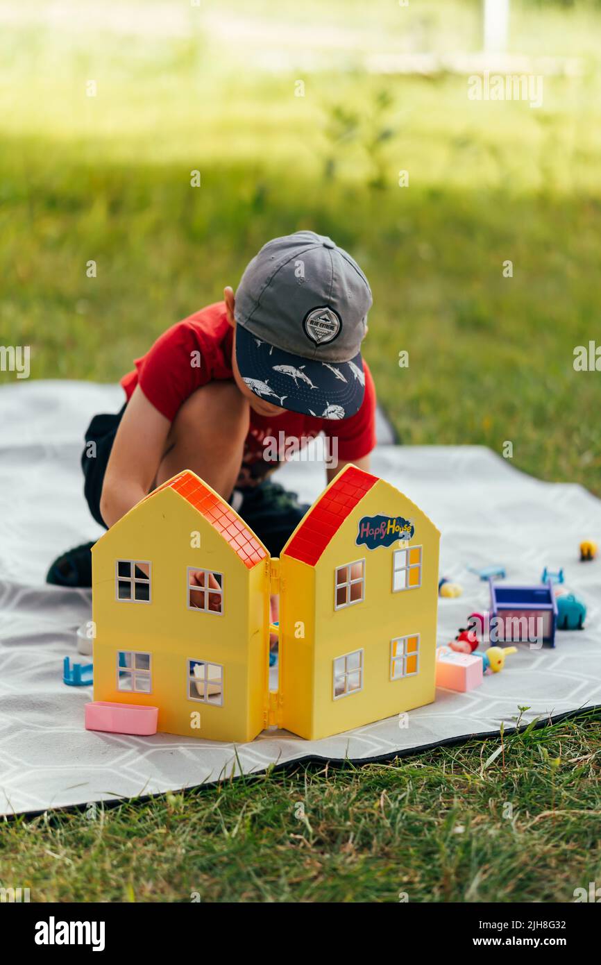 The vertical view of a child playing on the blanket over the green ...