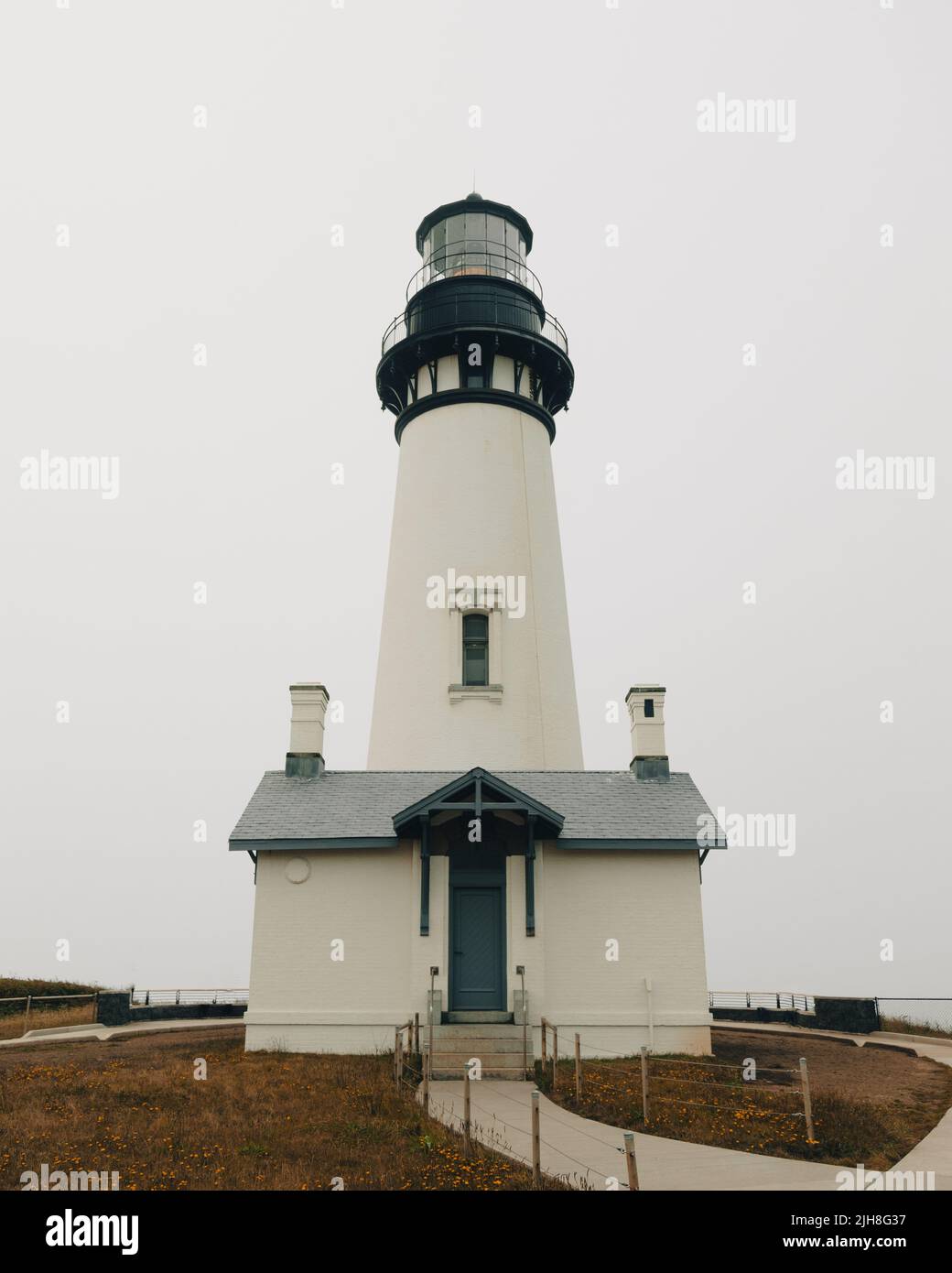 Beautiful shot of a tall lighthouse tower beacon at the shore of the ...