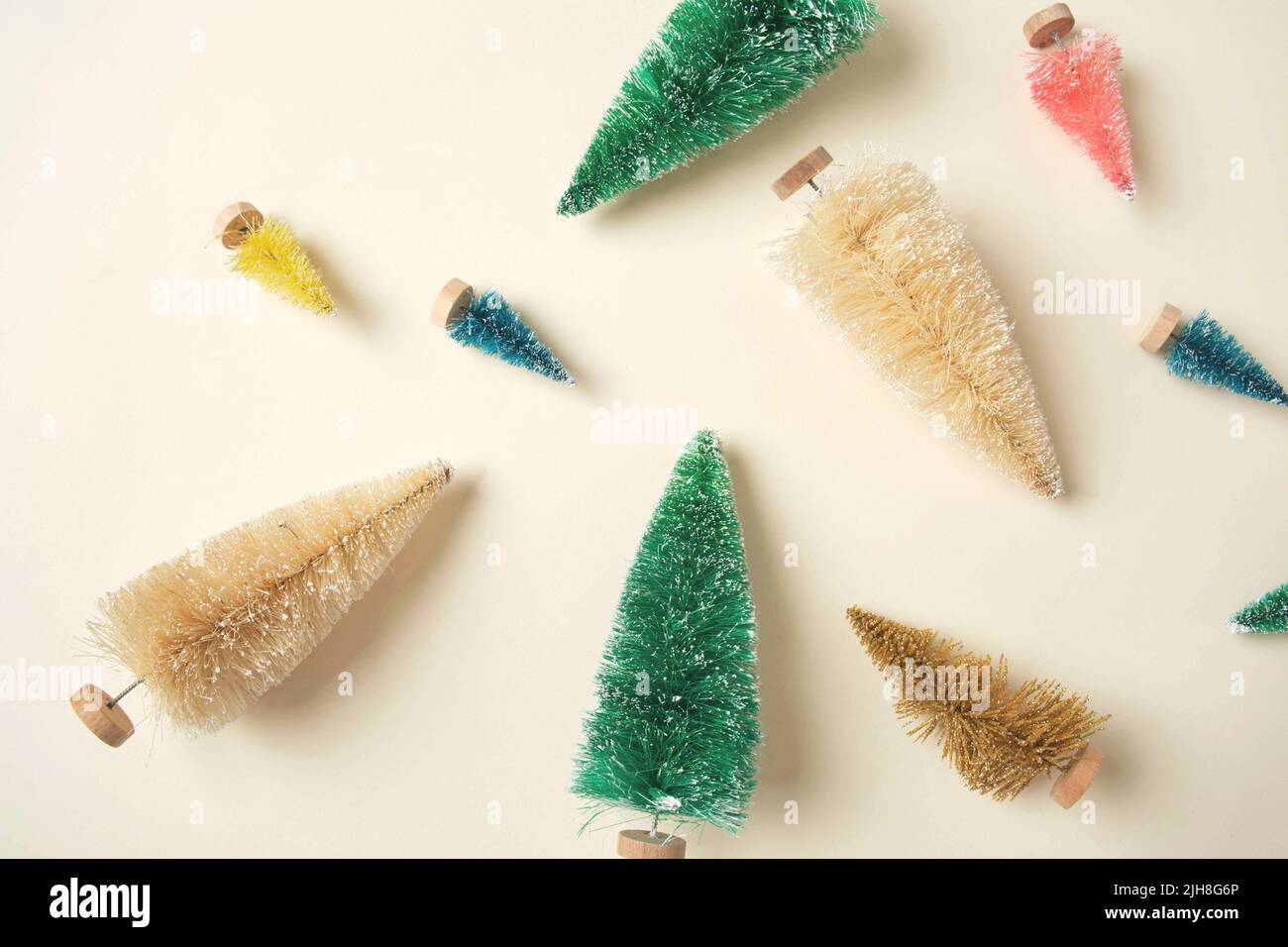 A top view of a small colorful decorative Christmas trees on a light ...