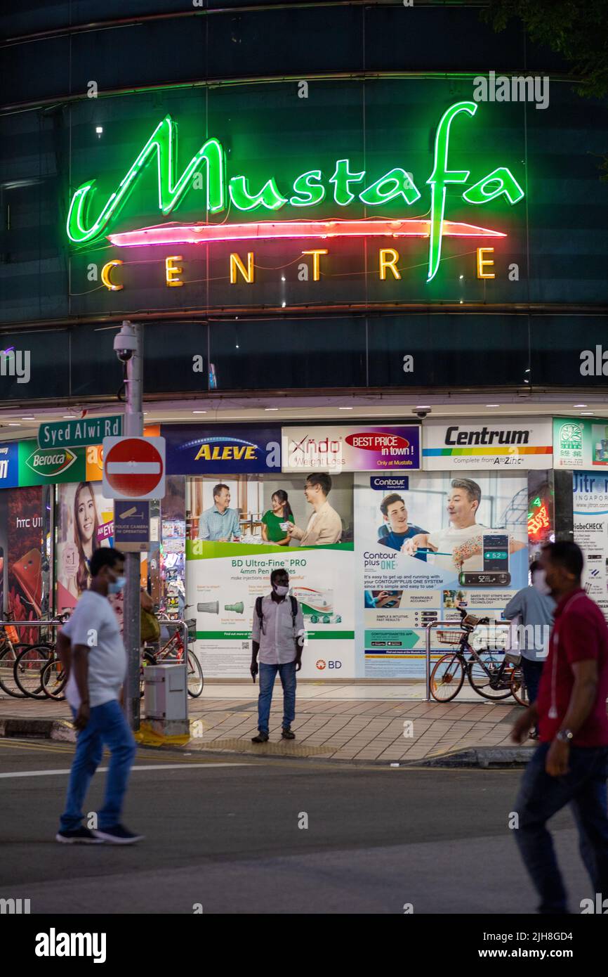A vertical shot of people crossing the street with the background of ...