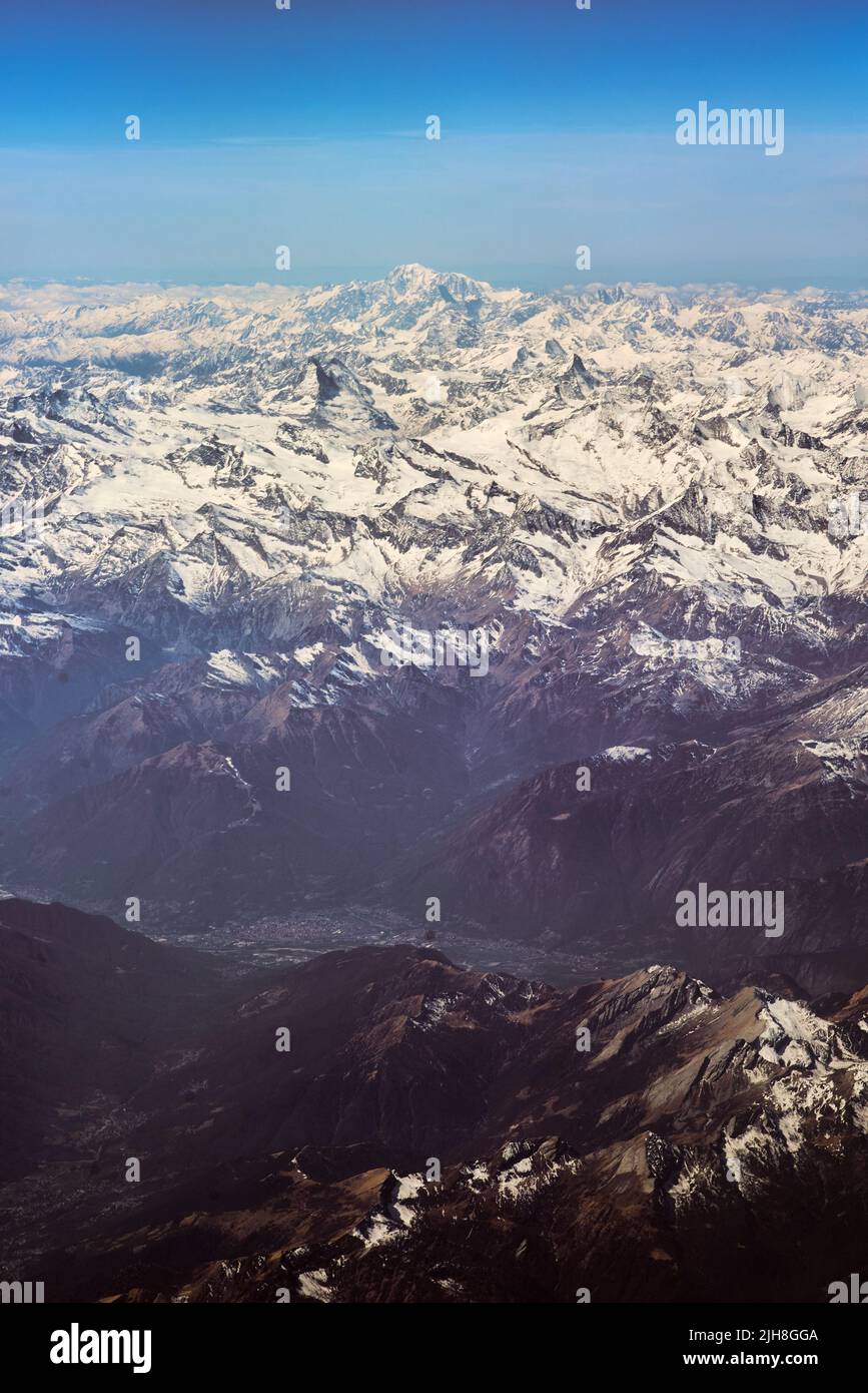 A vertical bird's-eye view of snowy mountain peaks Stock Photo - Alamy