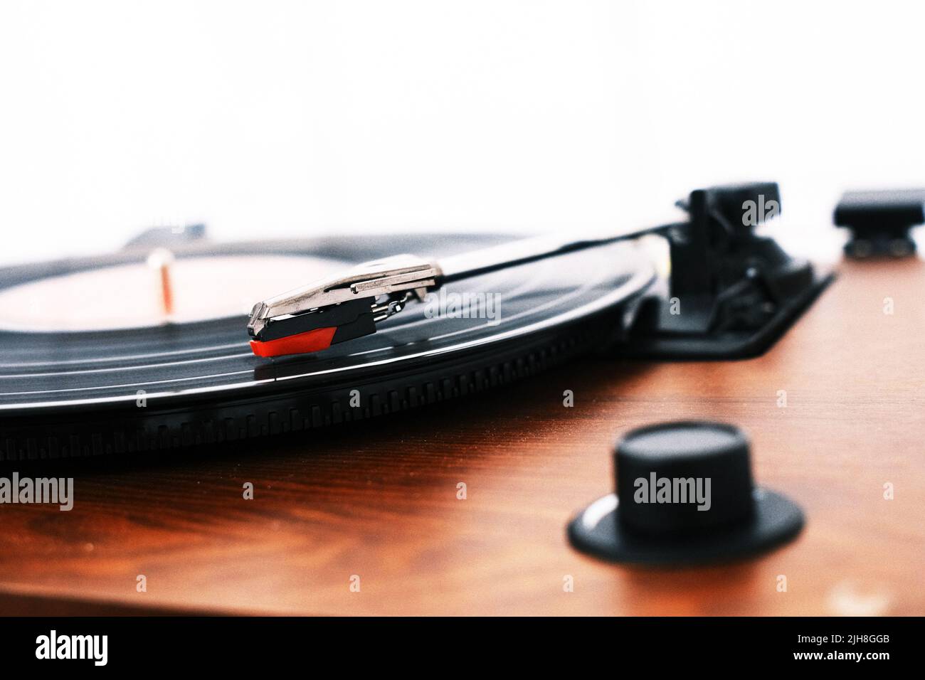 The vinyl disc playing on the wooden retro record player Stock Photo ...