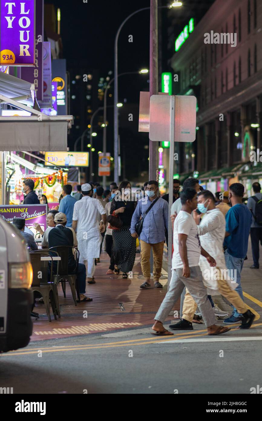 A vertical shot of people walking around the Farrer Park area Stock ...