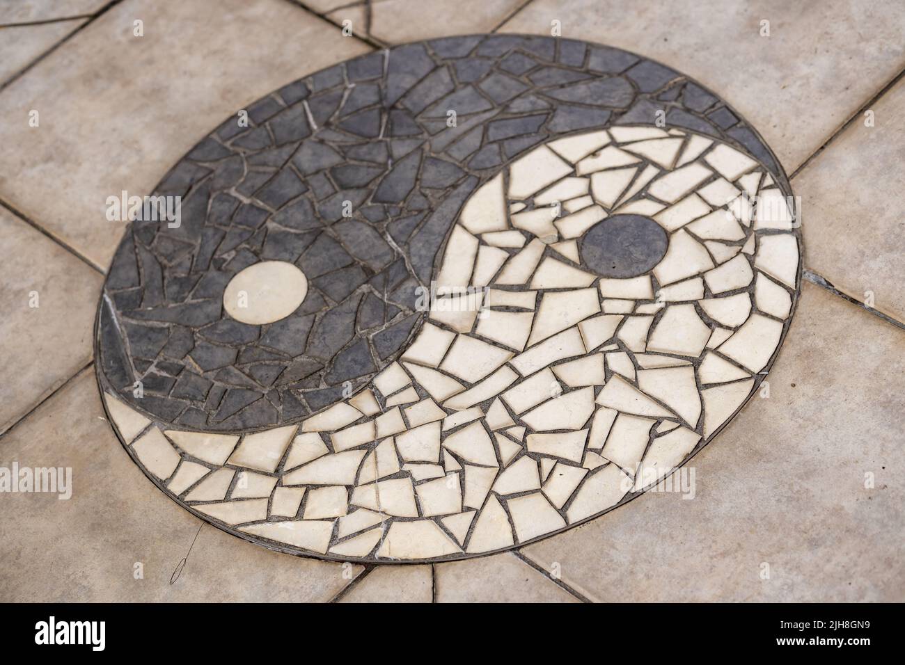 A Yin Yang symbol mosaic on a tiles floor Stock Photo - Alamy