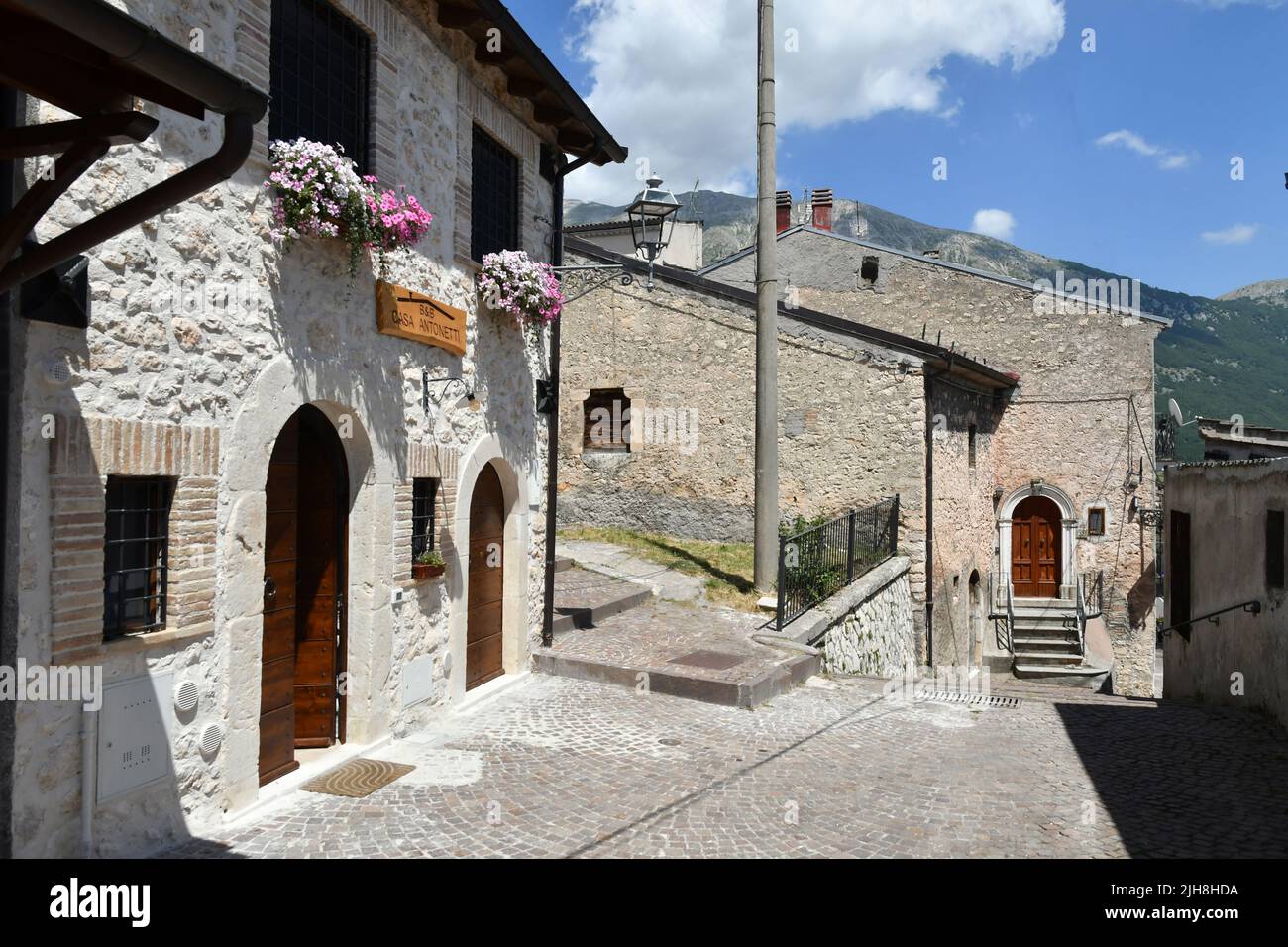 A street among the old stone houses of Campo di Giove, a medieval ...