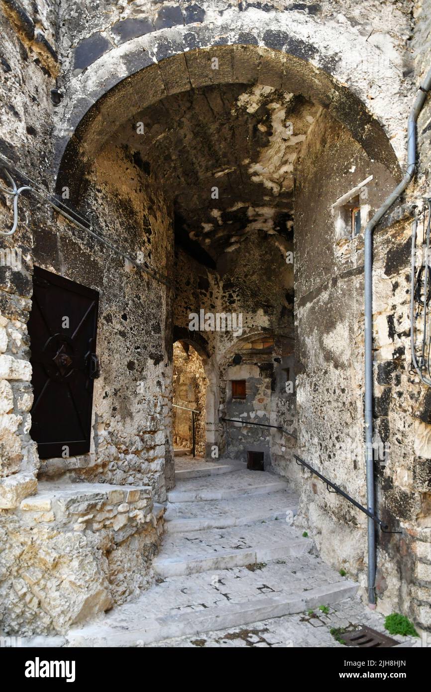 A narrow street between the old stone houses of Campo di Giove, a ...