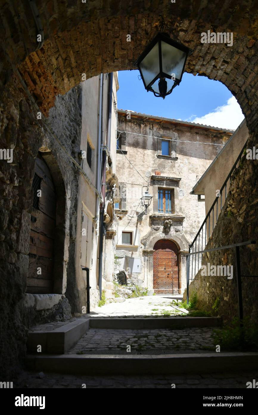 A narrow street between the old stone houses of Campo di Giove, a ...