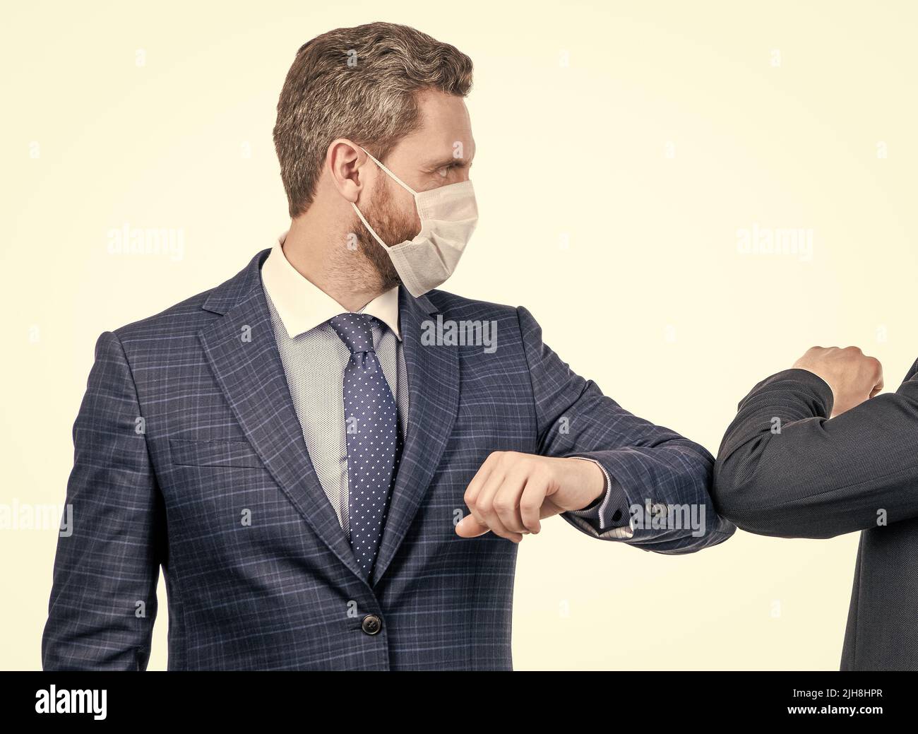 Businessman face mask touching elbow hi-res stock photography and ...