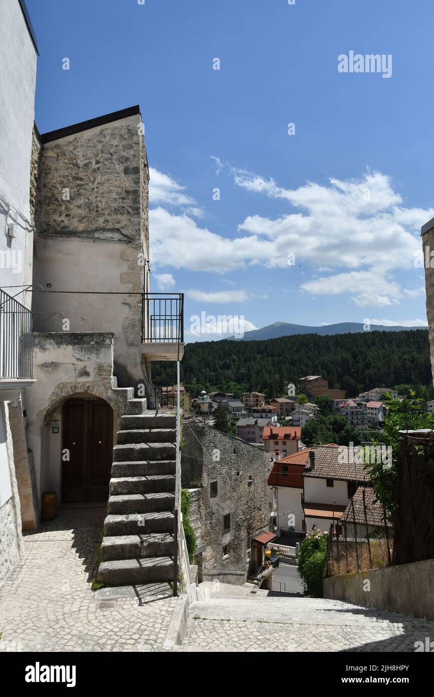 A narrow street between the old stone houses of Campo di Giove, a ...